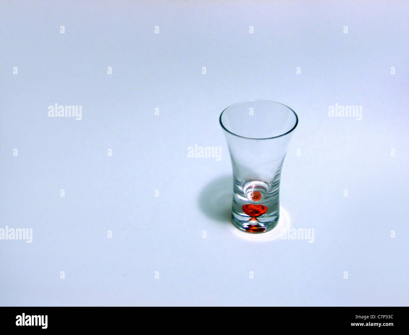 a single isolated shot glass over white Stock Photo - Alamy