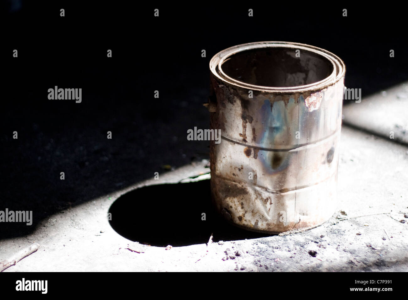 Still life shot of a rusty old paint bucket under dramatic lighting ...