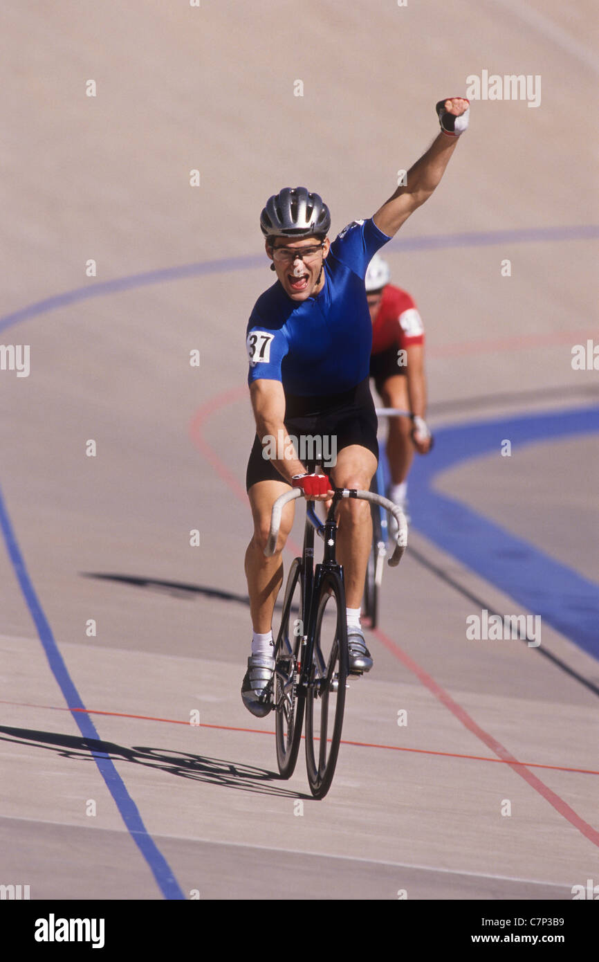 Cyclist celebrates after winning the race Stock Photo - Alamy