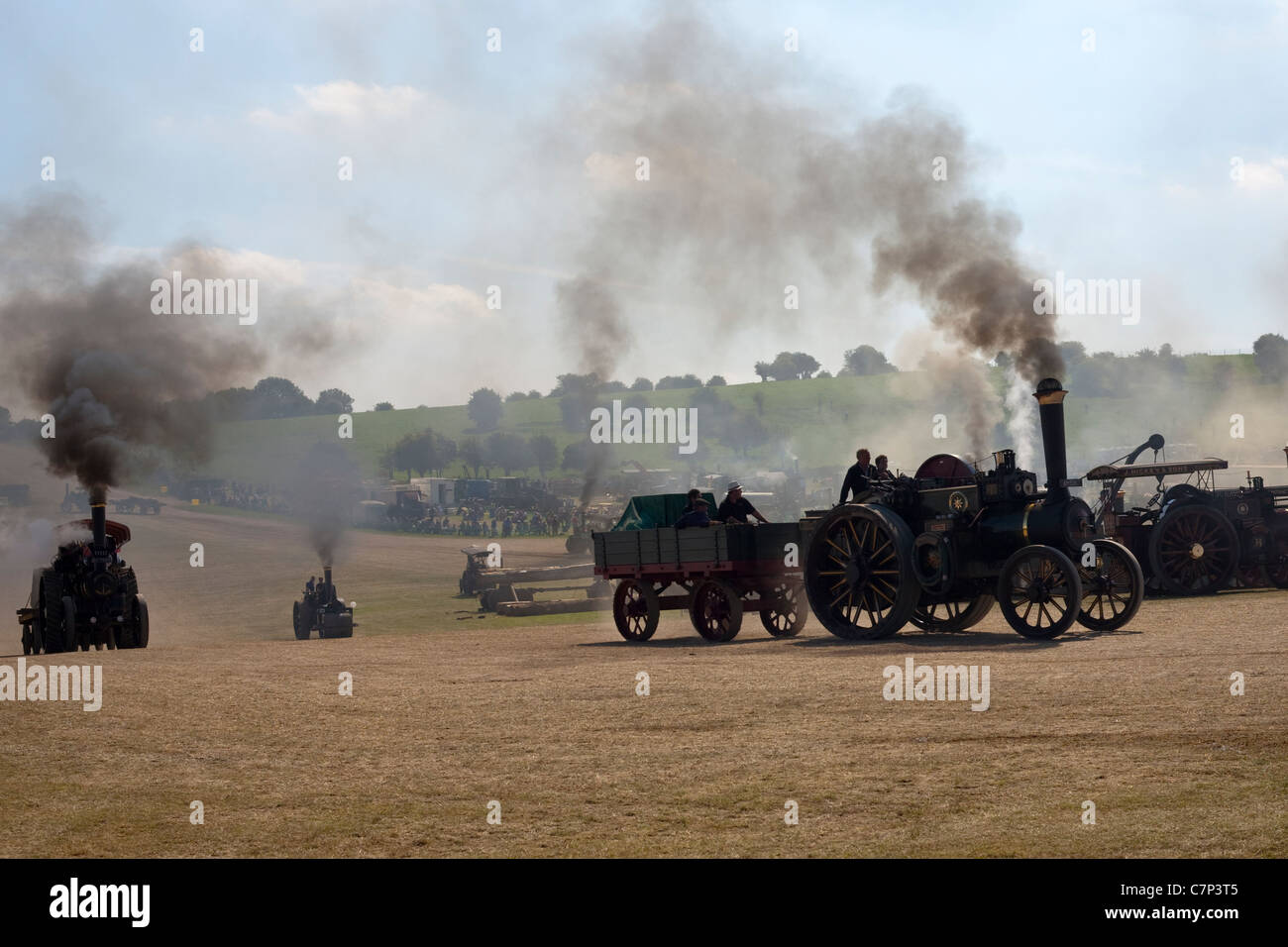 steam traction engine towing a trailer uphill with others in background ...