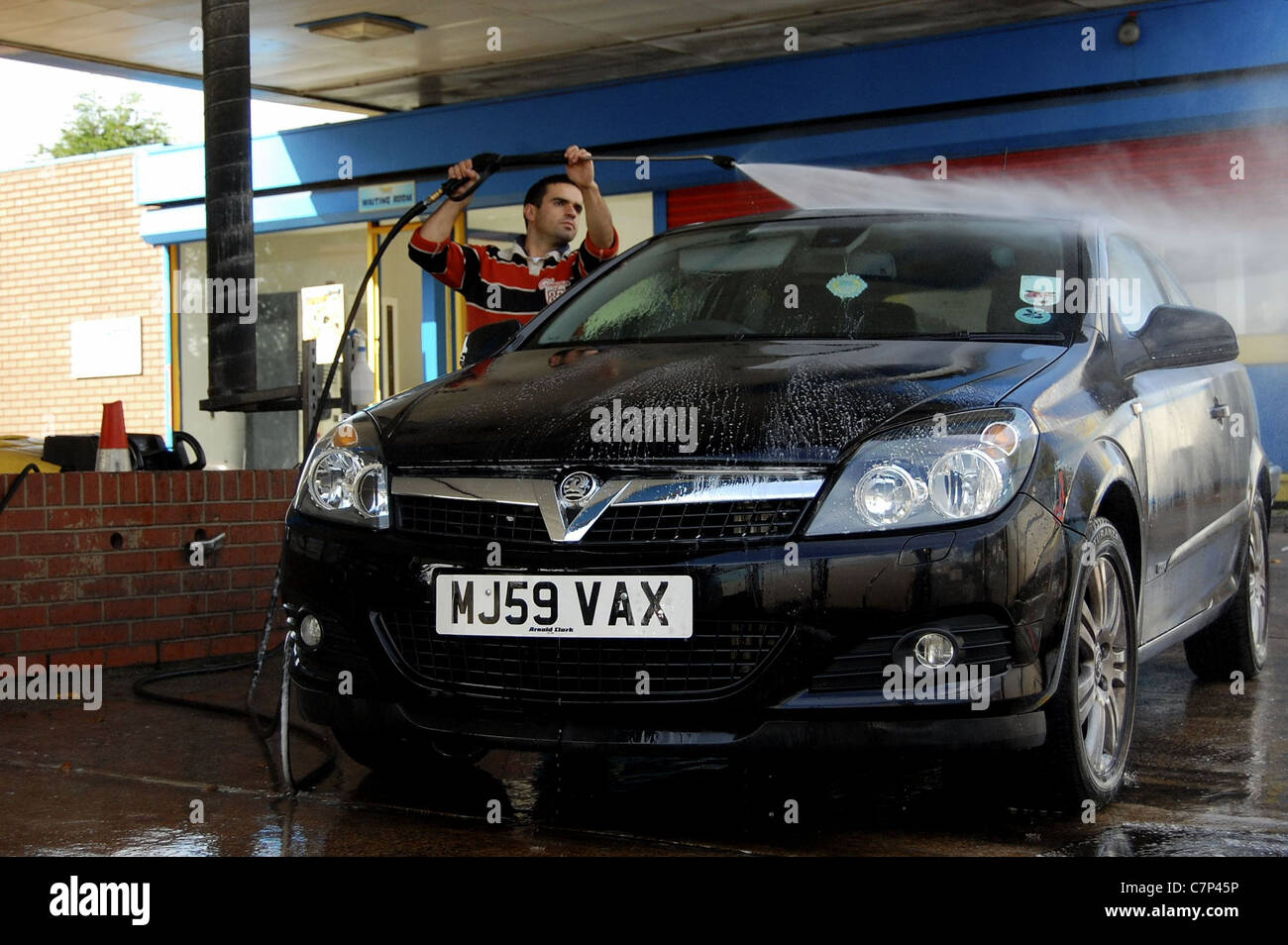 Car being rinsed with high pressure jet lance Stock Photo - Alamy