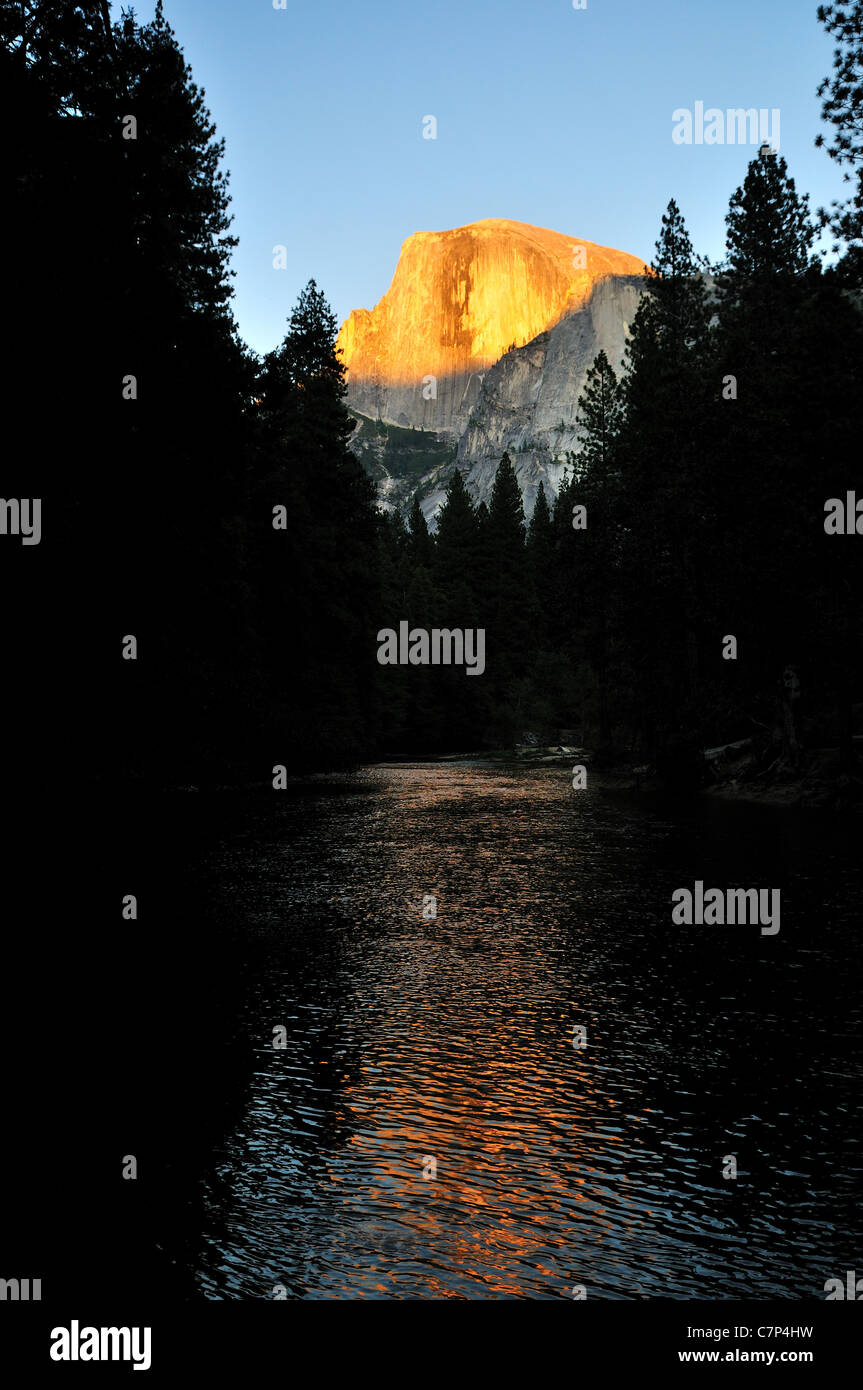 The Half Dome in sunset reflects in Merced River. Yosemite National ...