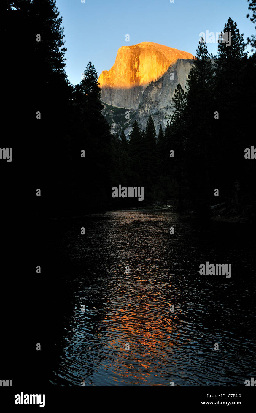 The Half Dome in sunset reflects in Merced River. Yosemite National ...