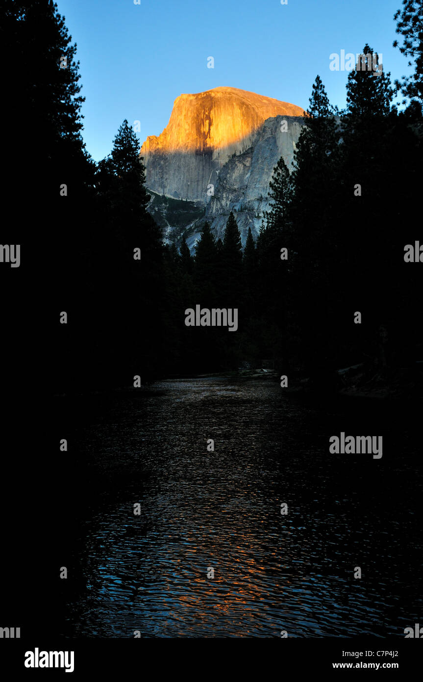 The Half Dome in sunset reflects in Merced River. Yosemite National ...