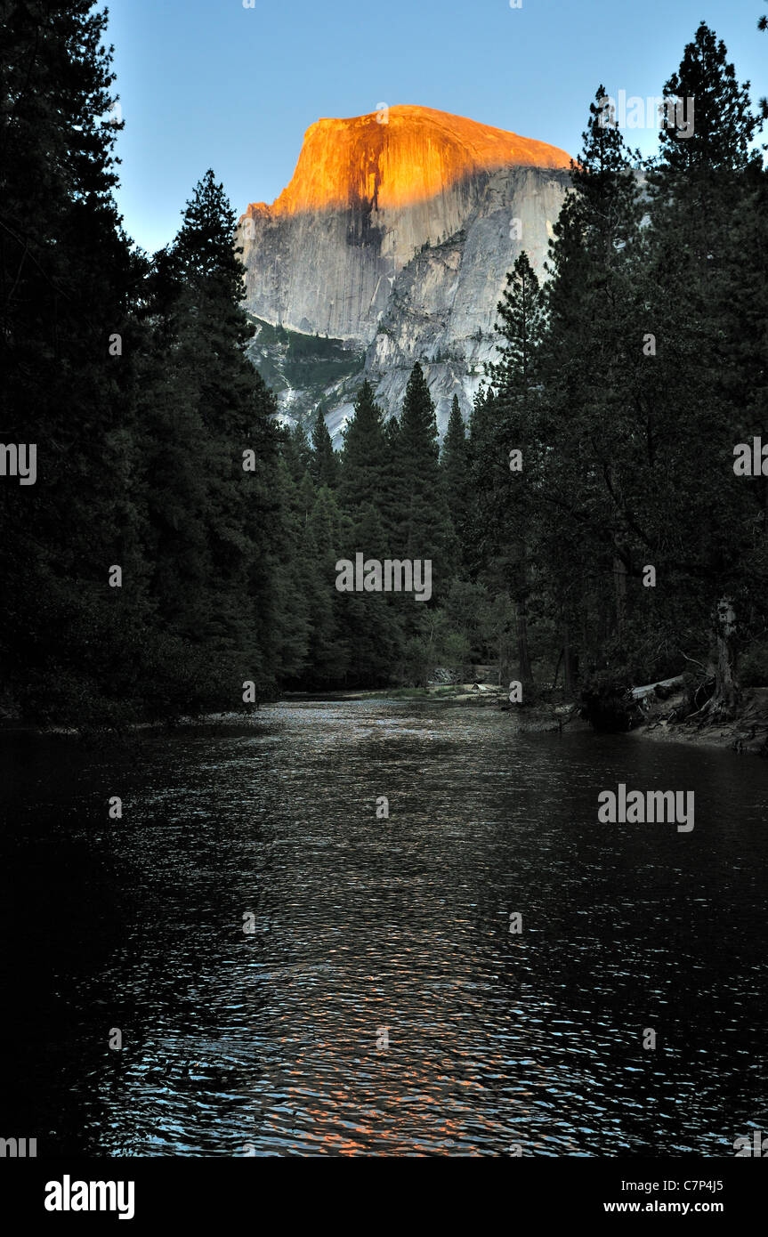 The Half Dome in sunset reflects in Merced River. Yosemite National ...