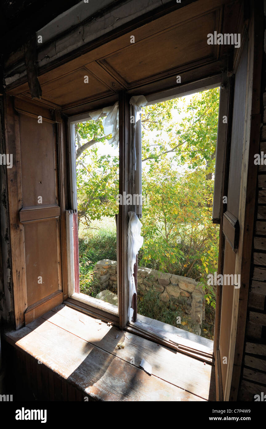 Inside of an old abandoned farm house in the middle of a field ...
