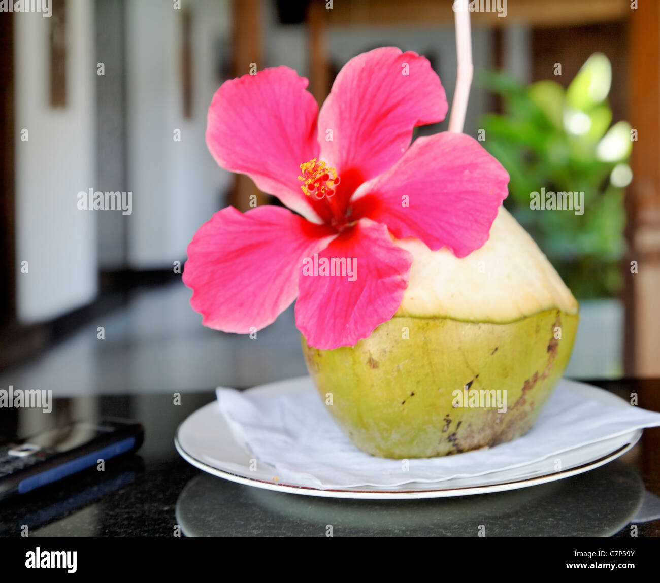 welcome coconut juice milk drink and straw dressed with Hibiscus a pink ...