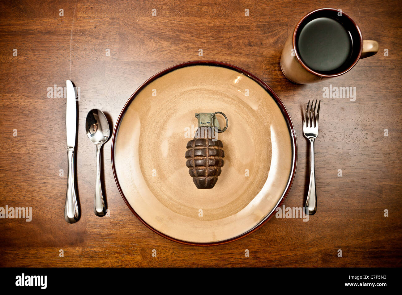 A grenade on a dinner plate Stock Photo - Alamy