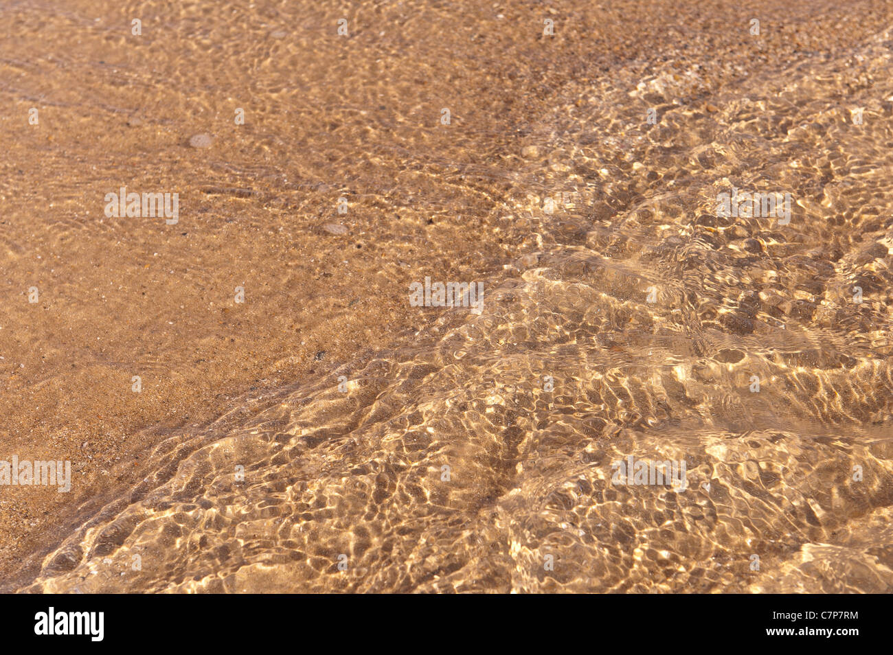 ripples reflections refraction wave patterns in shallow sea water on a ...