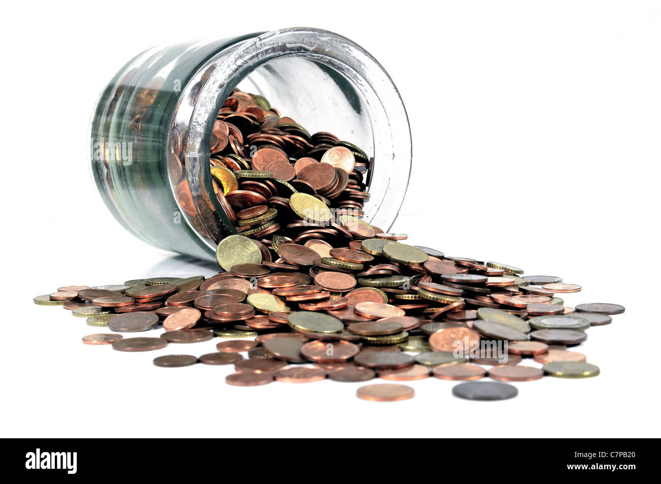 Glass money jar with spilling Euro cent coins on white background Stock ...