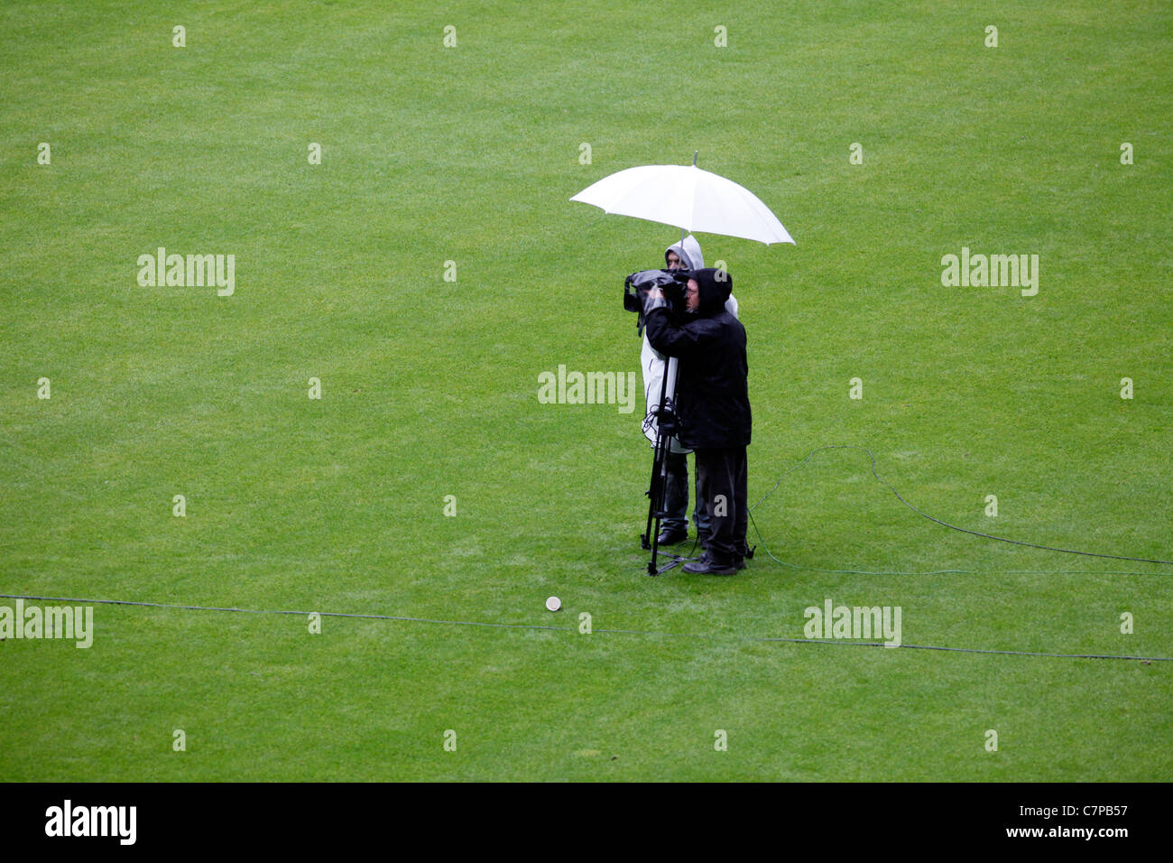 Television camera team, during a live coverage of an event, standing in ...
