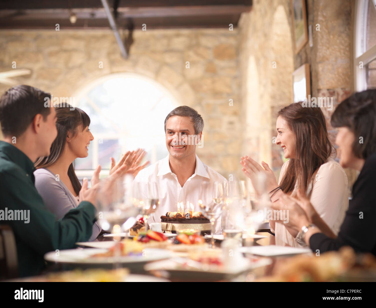 People celebrating in restaurant Stock Photo - Alamy