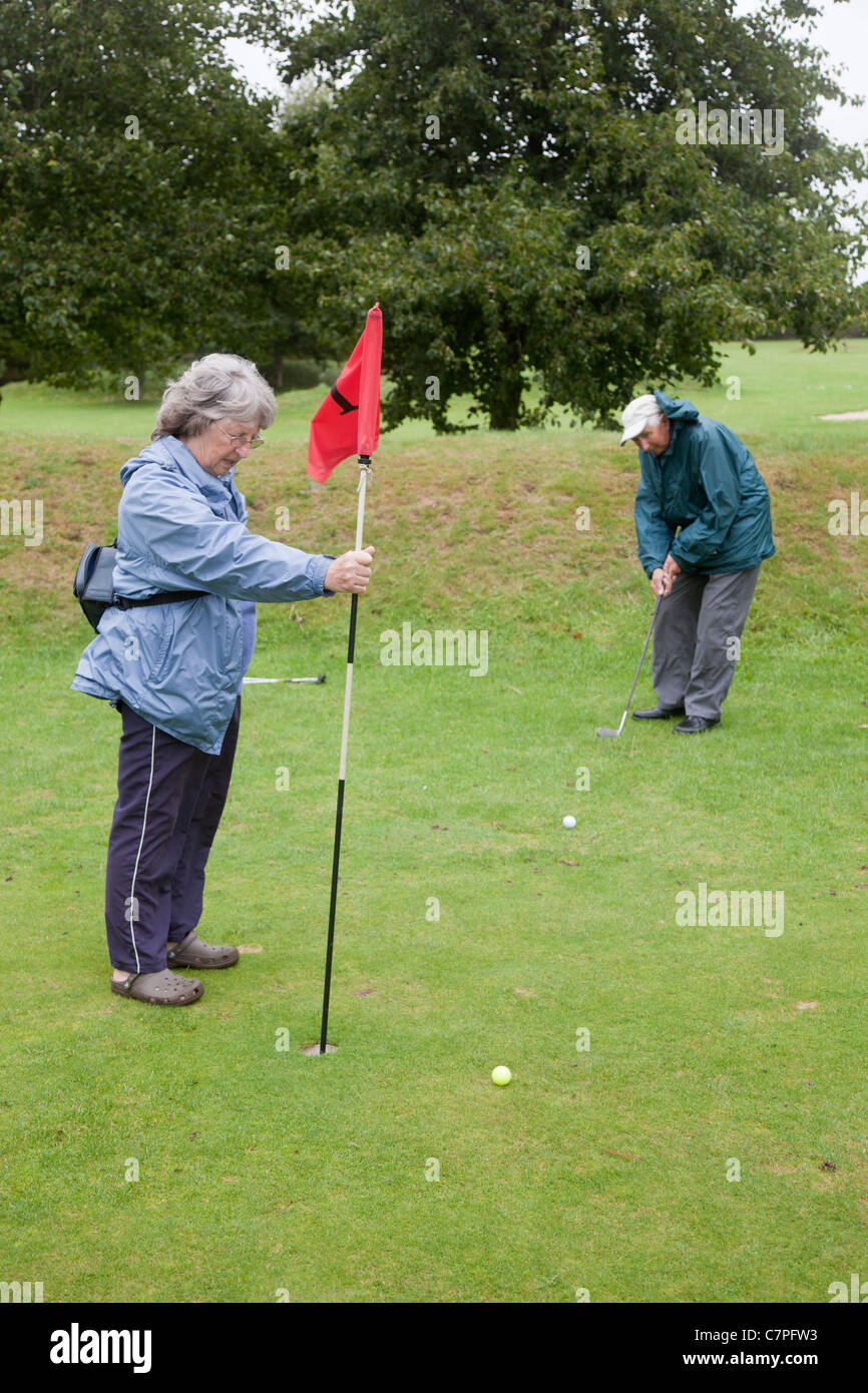 Elderly couple playing golf; Cornwall; UK Stock Photo - Alamy