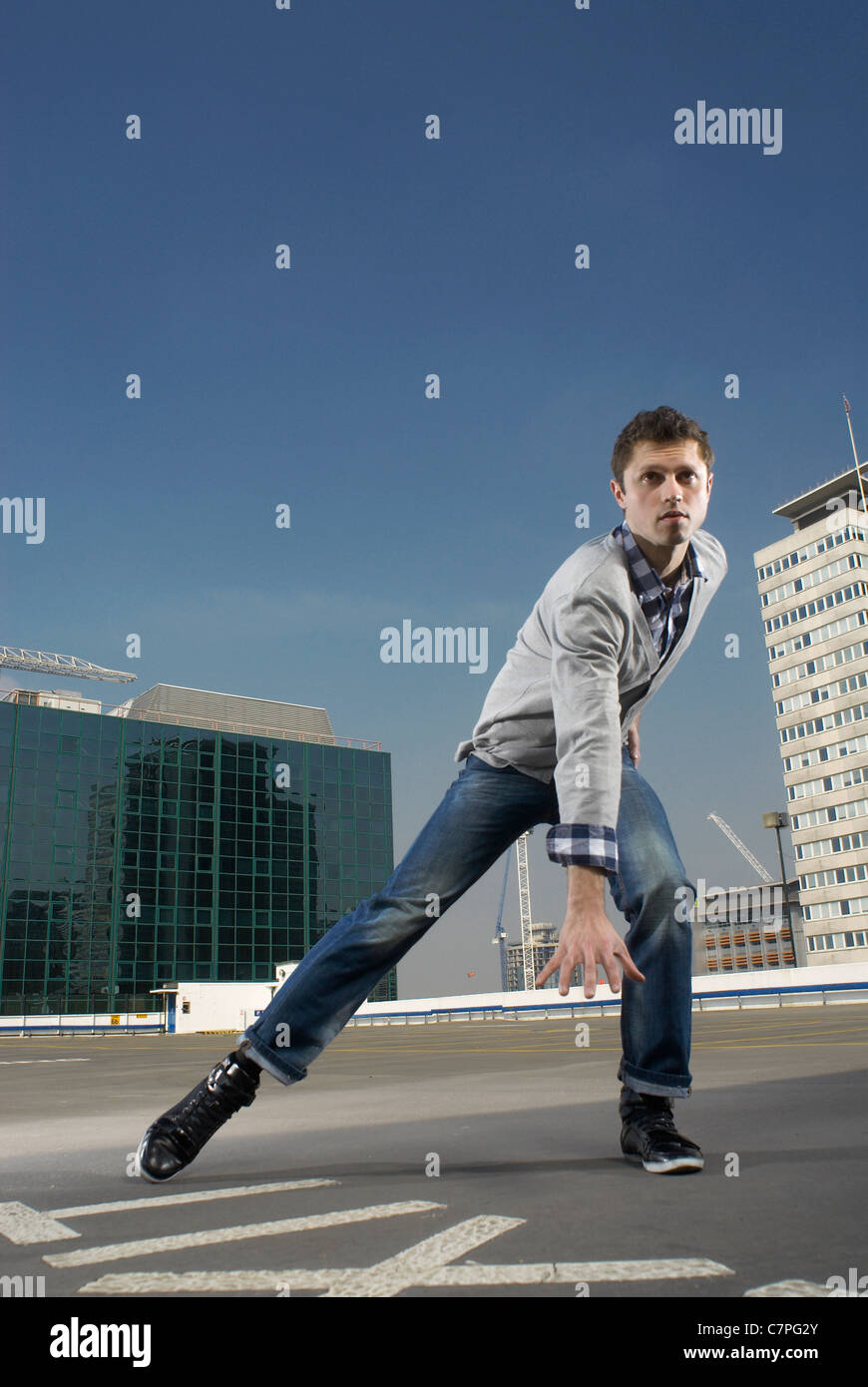 Man dancing on urban rooftop Stock Photo - Alamy