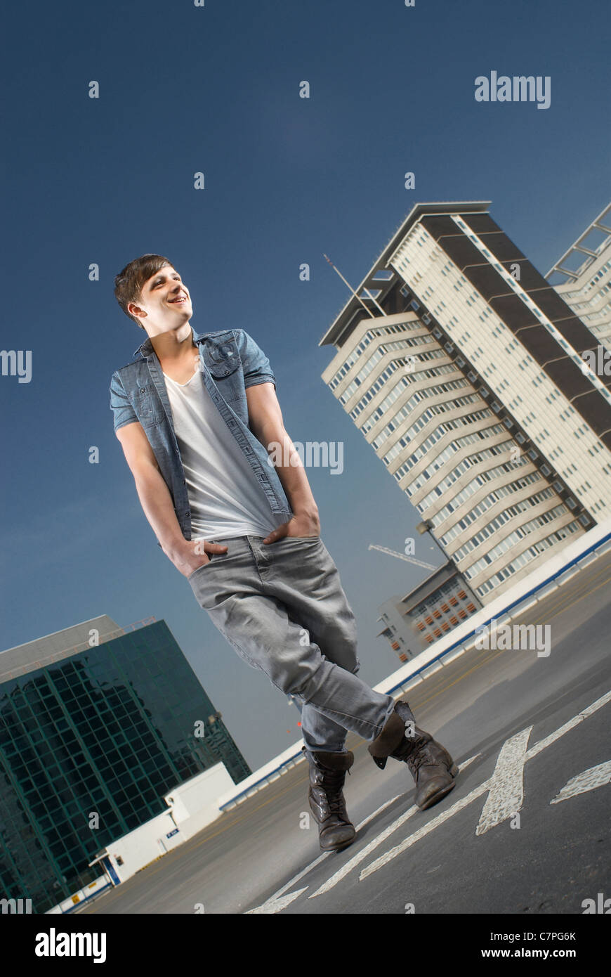 Man standing on urban rooftop Stock Photo - Alamy