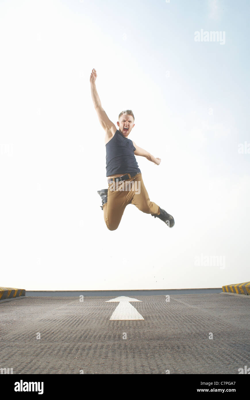 Man jumping in road Stock Photo - Alamy