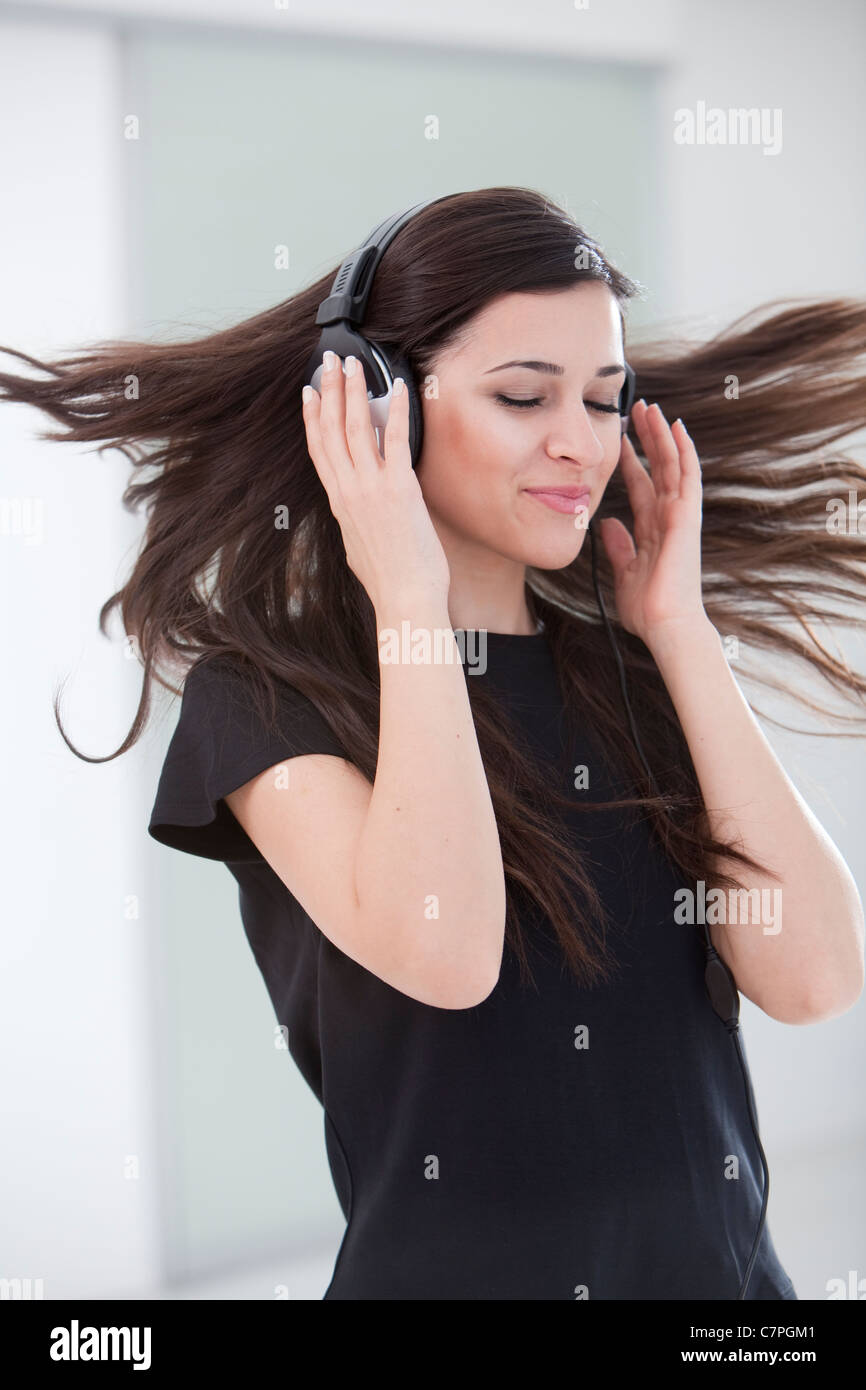 Woman dancing in headphones Stock Photo - Alamy
