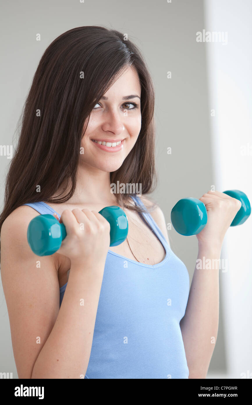 Woman lifting hand weights Stock Photo - Alamy