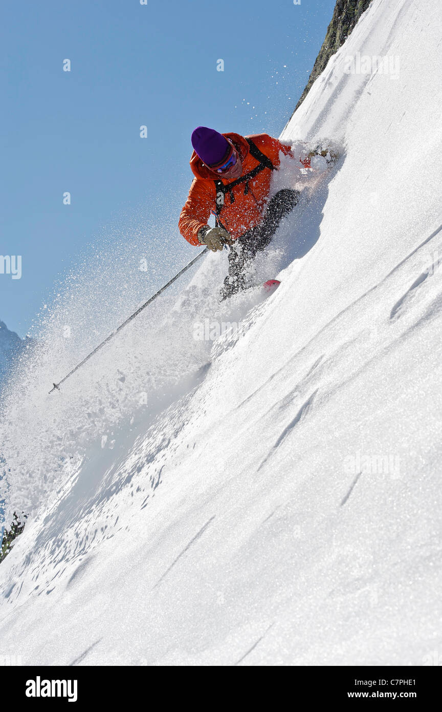 Skier turning on steep mountain face Stock Photo - Alamy