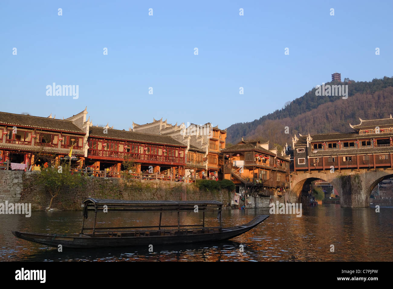 China river landscape with boat and ancient building in Fenghuang ...