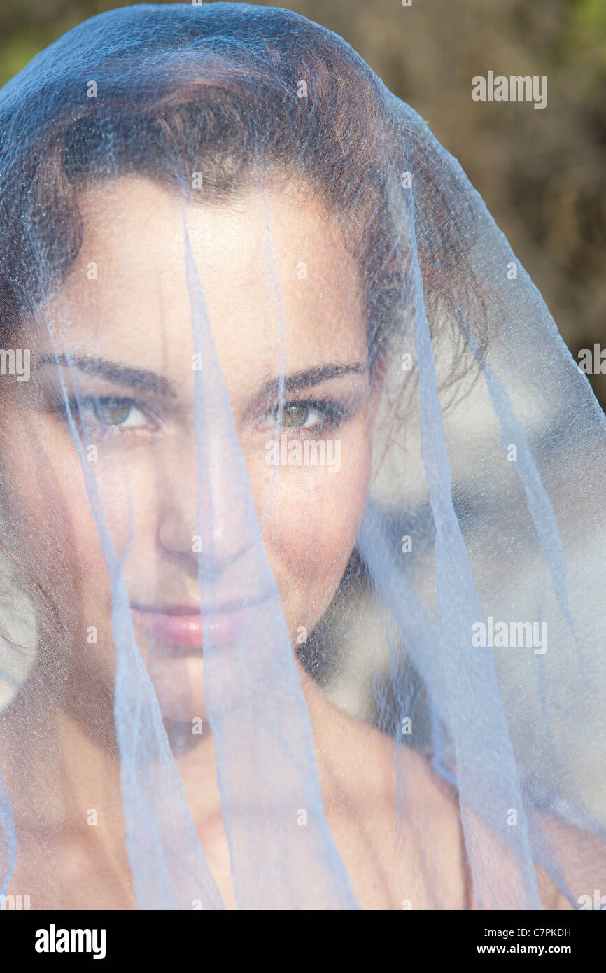 Woman under veil on beach Stock Photo - Alamy