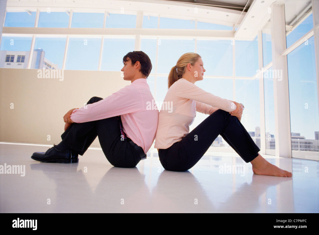 Business people sitting back-to-back Stock Photo - Alamy