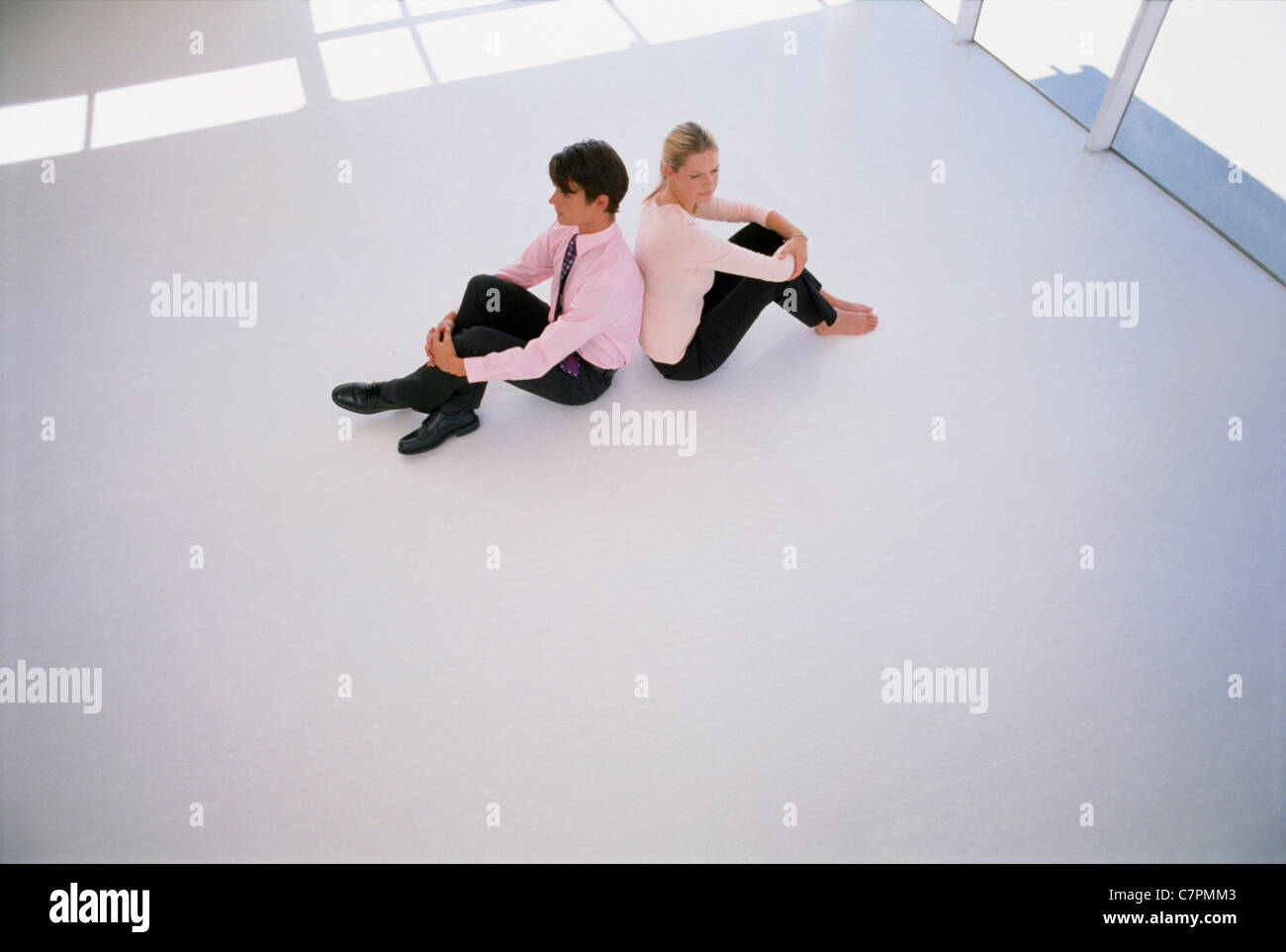 Businesspeople sitting back-to-back Stock Photo - Alamy