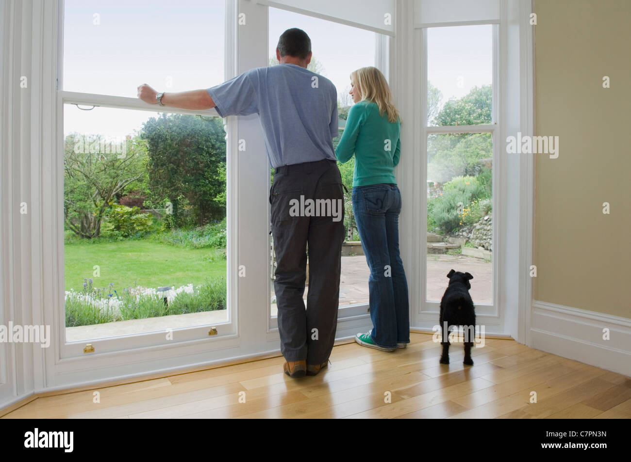 Couple and dog admiring new home Stock Photo - Alamy Couple and dog admiring new home Stock Photo - Alamy