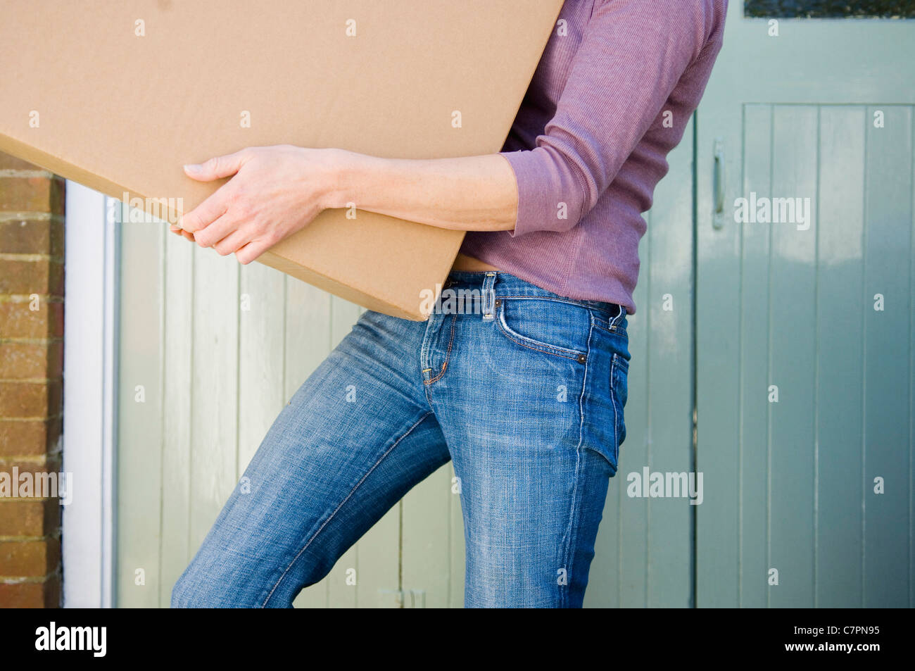 Woman carrying cardboard box Stock Photo - Alamy