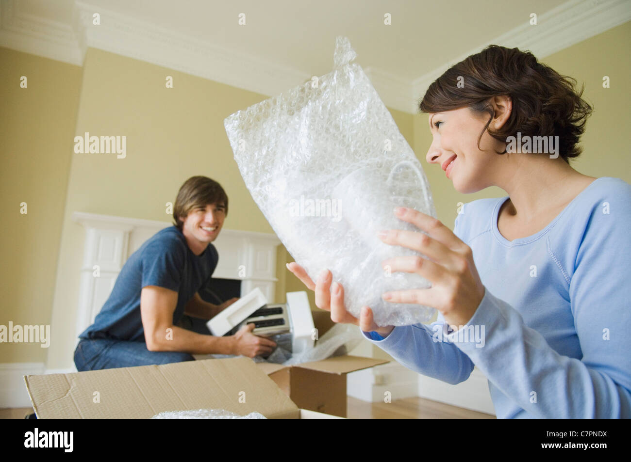 Couple unpacking boxes in new home Stock Photo - Alamy