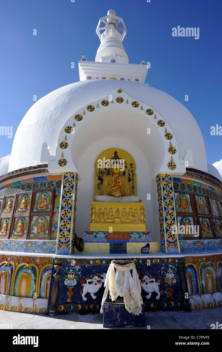 The main golden image of the Buddha on the dome of the Shanti Stupa ...
