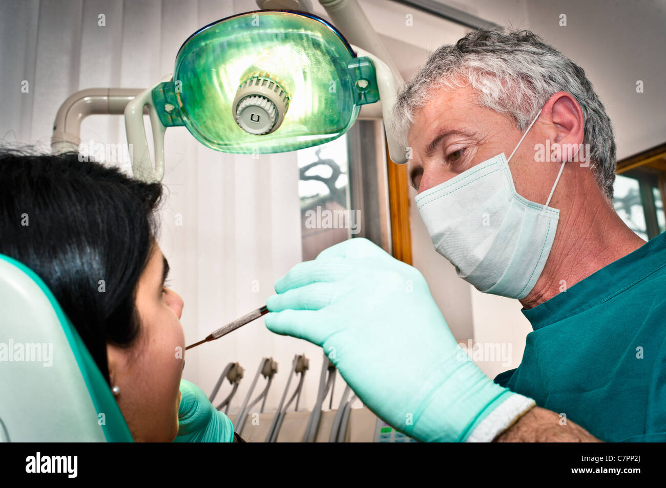 Dentist working on patient in office Stock Photo - Alamy