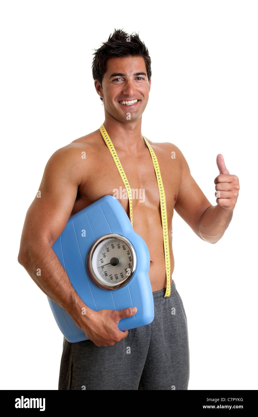 Muscular young man with weight scale Stock Photo - Alamy
