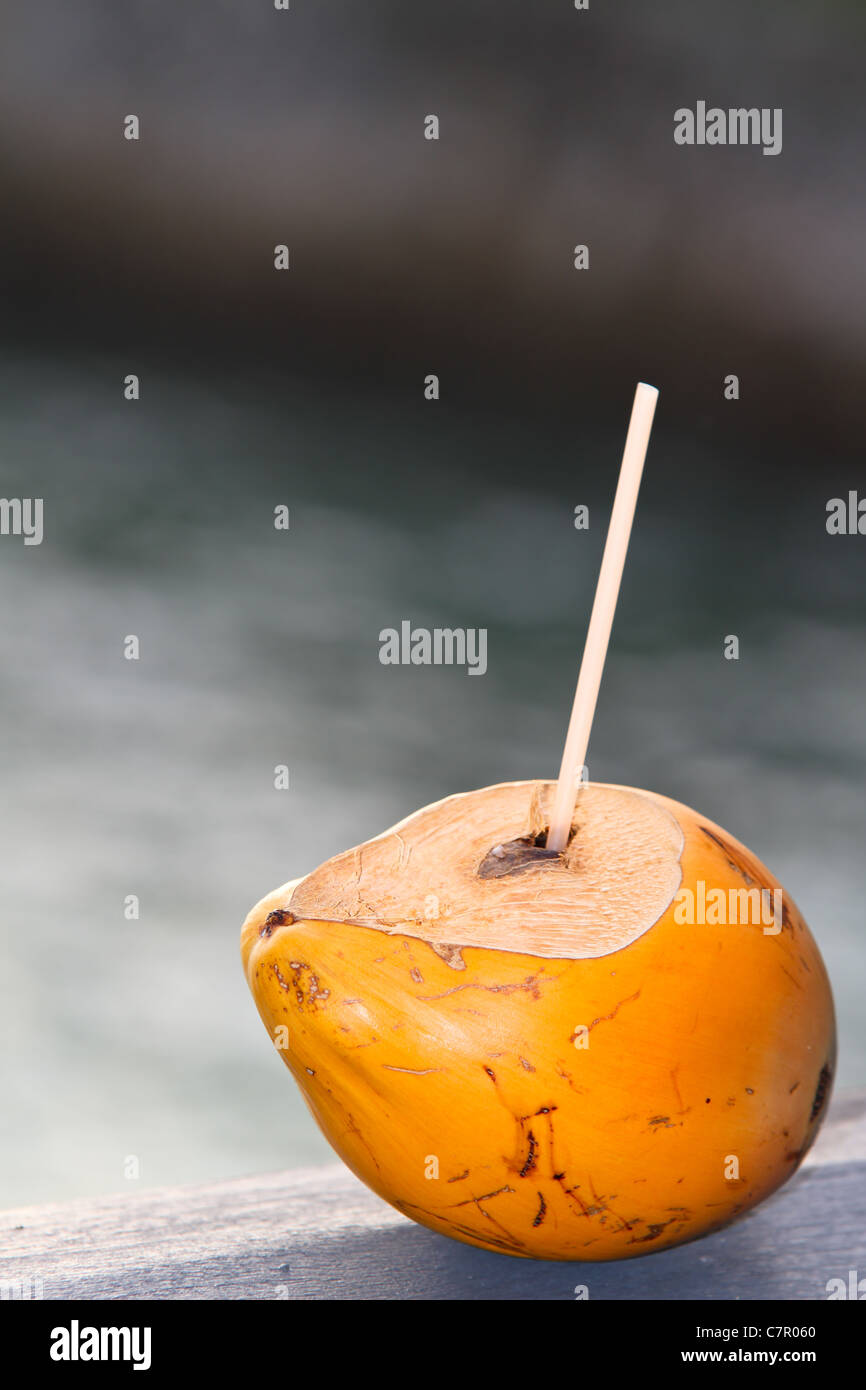 Coconut with straw Stock Photo - Alamy