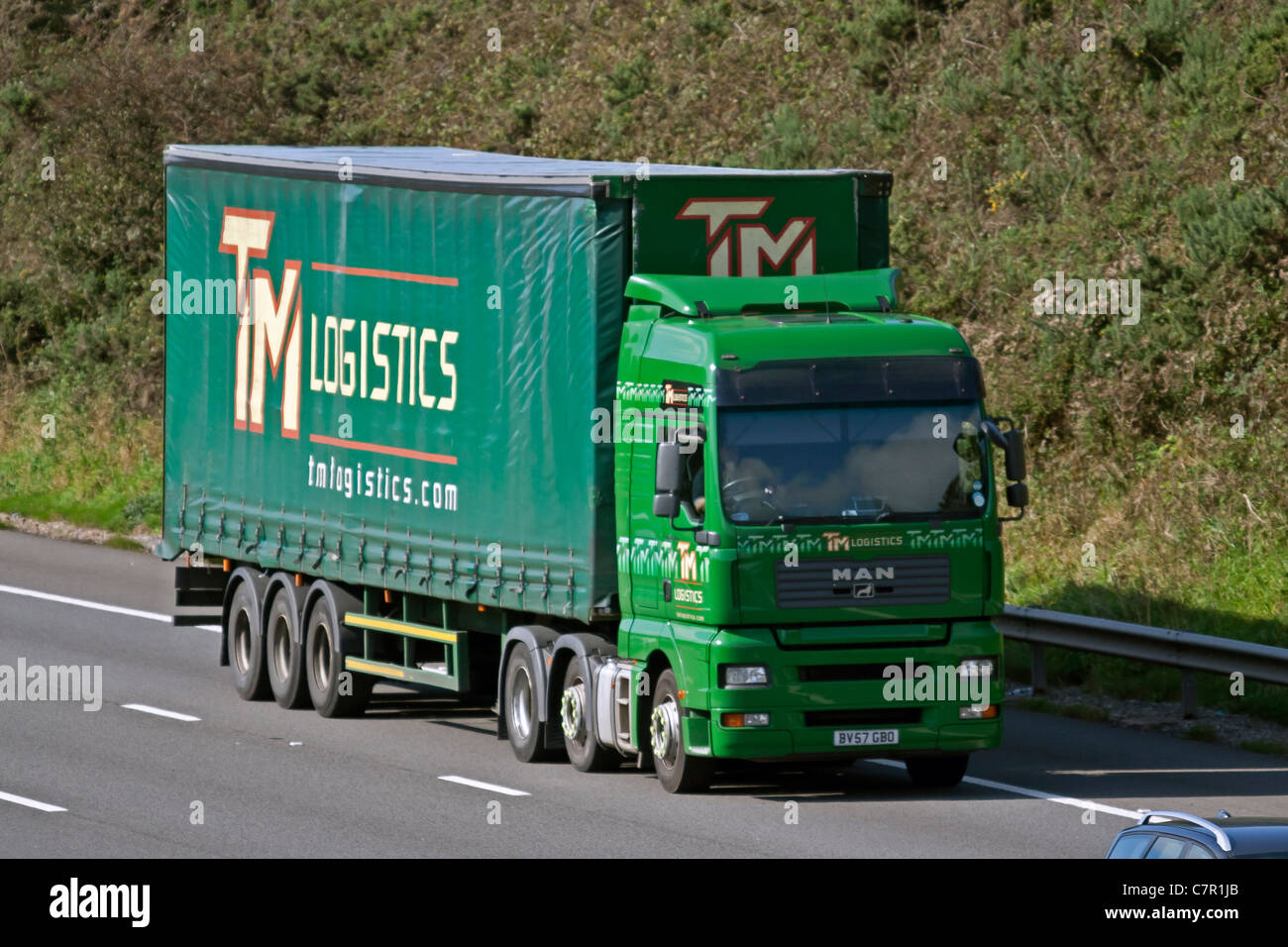 TM Logistics Green MAN tractor unit and trailer on the m4 motorway ...