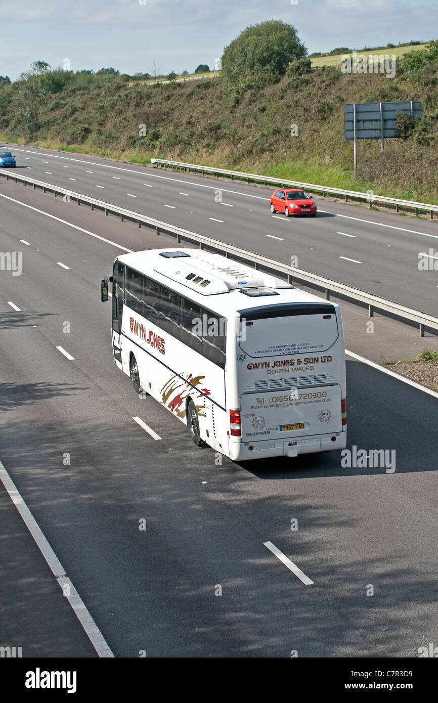 A bus or coach traveling on the M4 motorway in South Wales is a common ...
