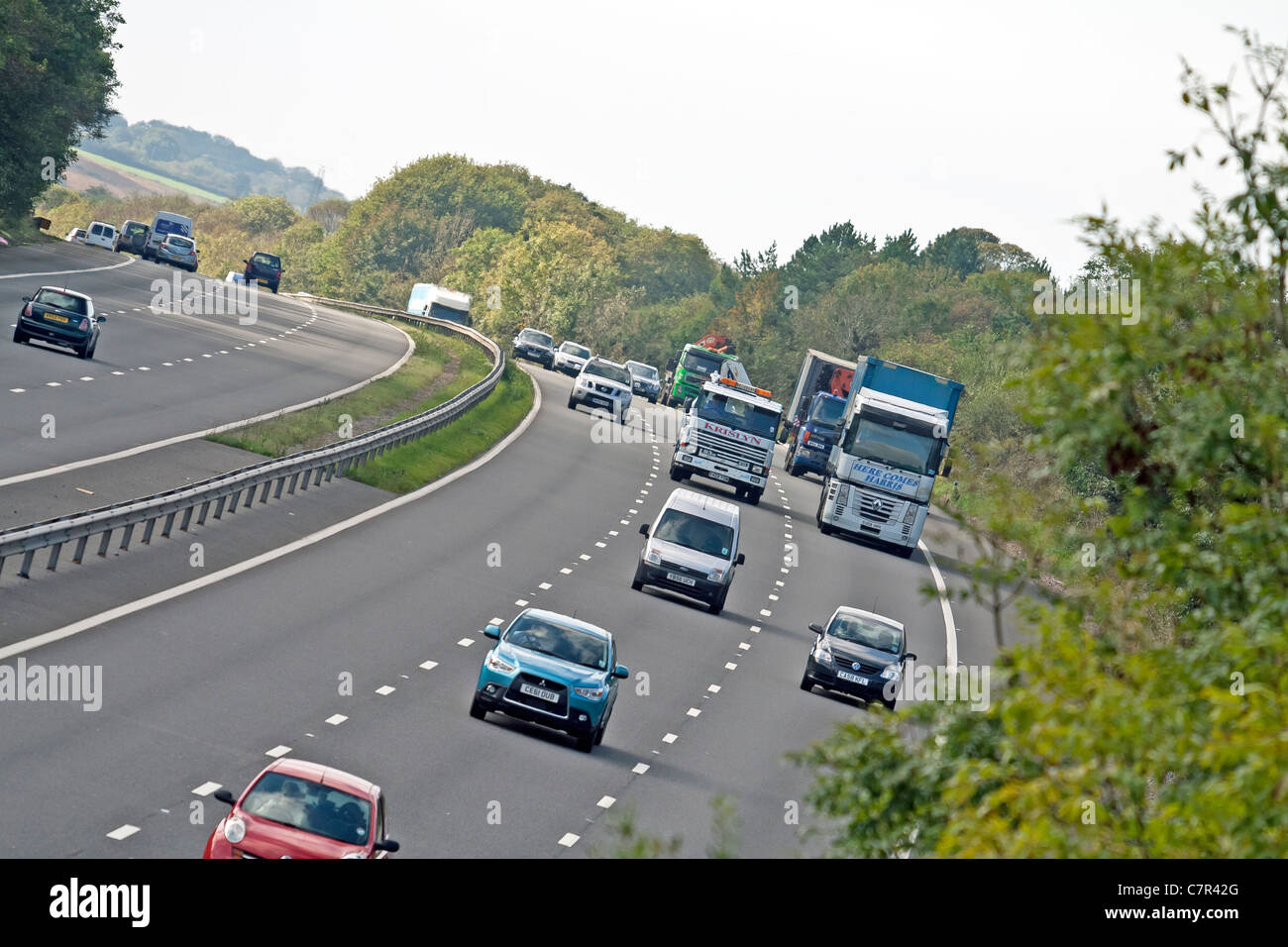 Busy road or motorway with trucks and cars Stock Photo - Alamy