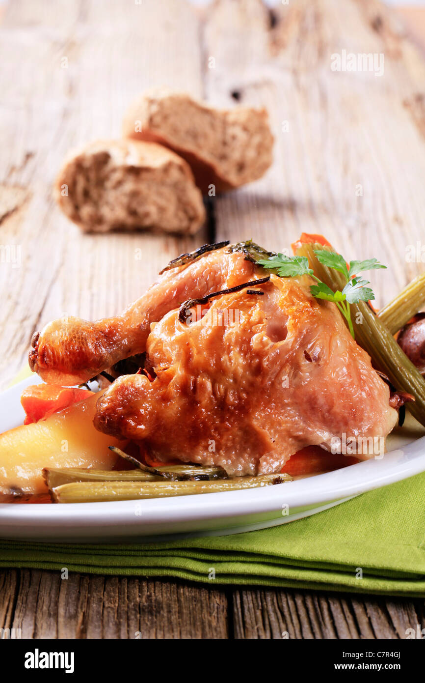 Cooked chicken leg and vegetables - closeup Stock Photo - Alamy