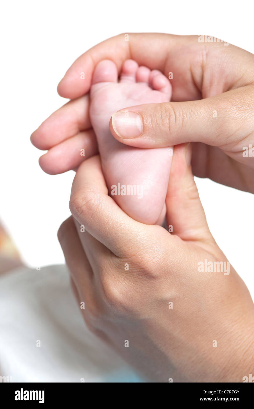 massaging foot of little baby Stock Photo - Alamy