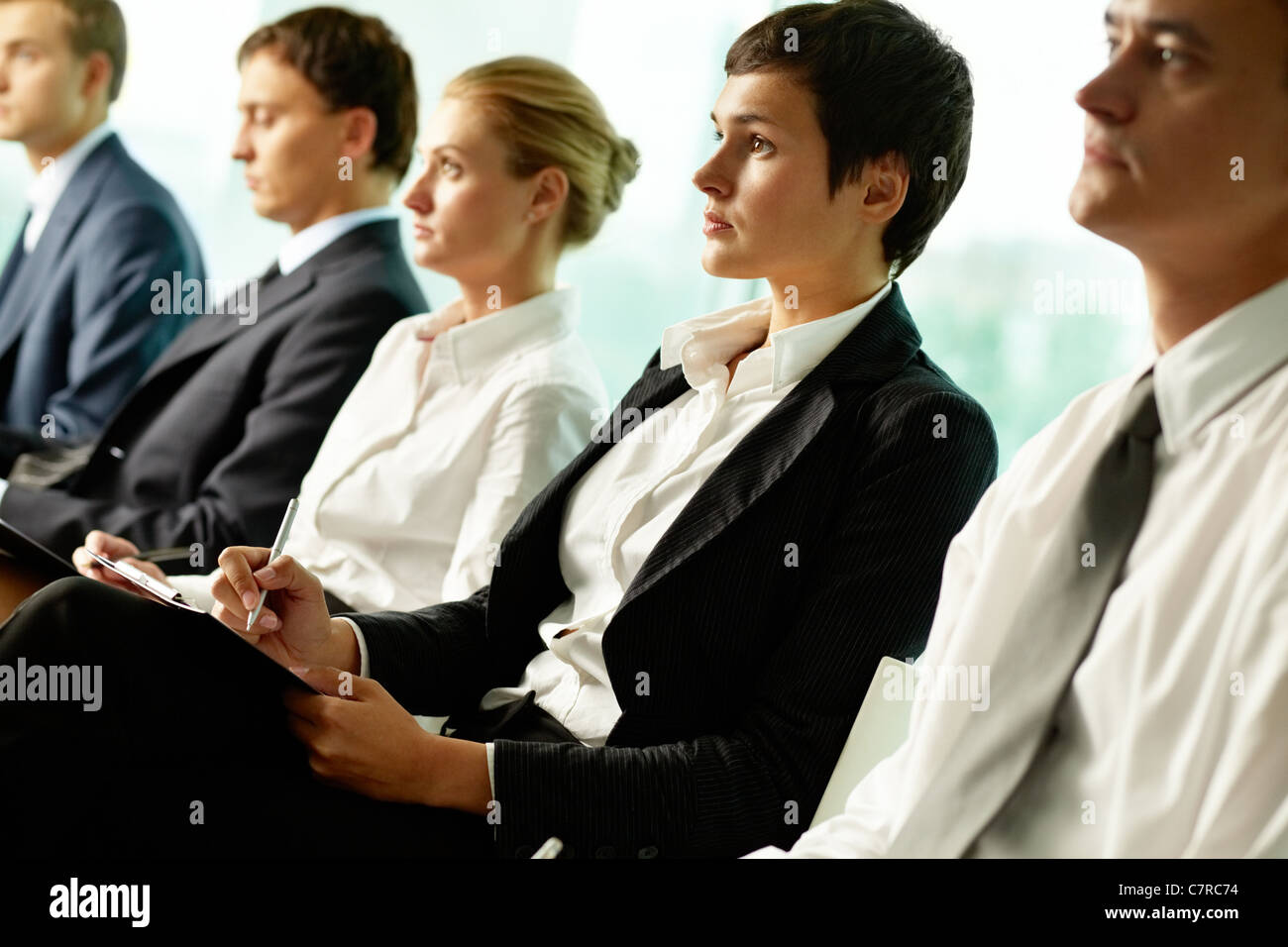 Business people sitting in a row at seminar Stock Photo - Alamy