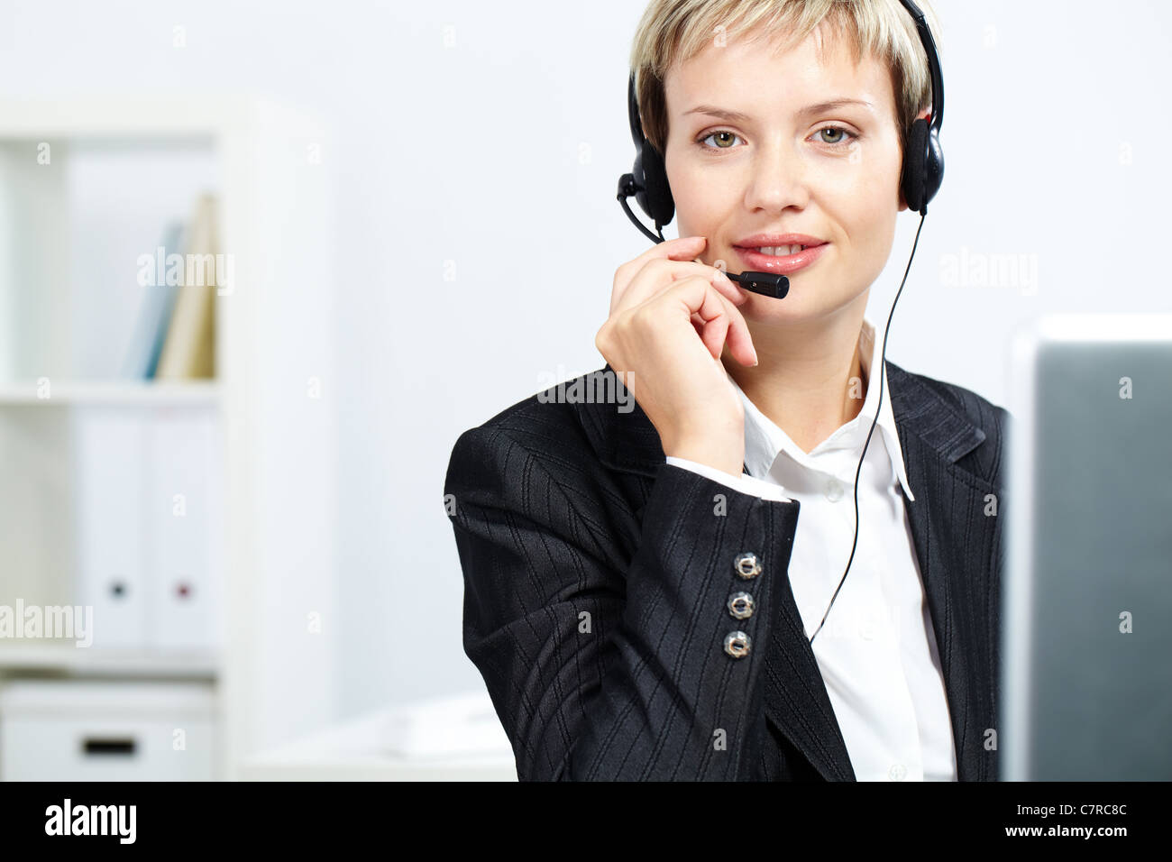 Portrait of attractive receptionist with headset Stock Photo - Alamy