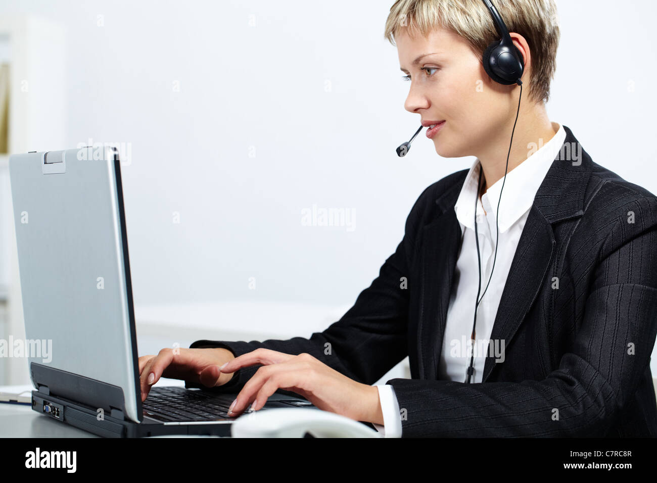 Young operator working with laptop Stock Photo - Alamy