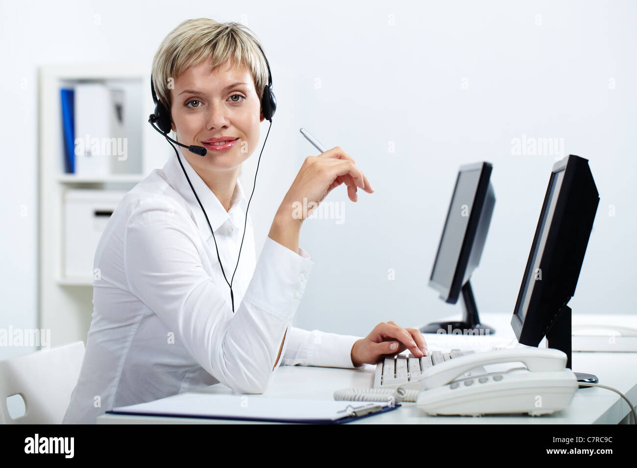 Portrait of office manager working in waiting room Stock Photo - Alamy