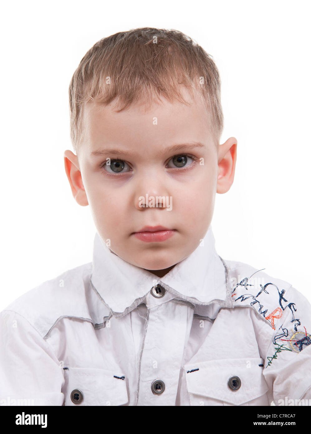 Serious boy standing on white background Stock Photo - Alamy