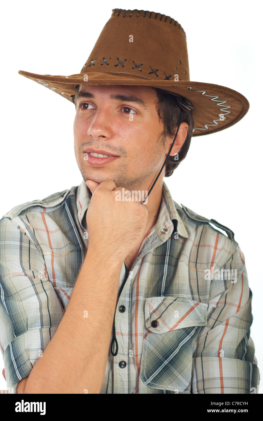 Smiling cowboy looking away and wearing brown hat isolated on white ...