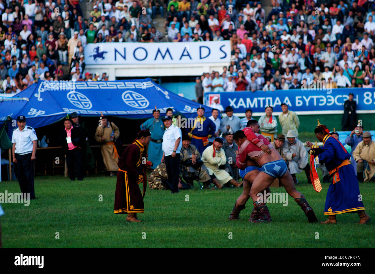 Mongolian wrestlers w/ "nomads" sign in background, Naadam Festival ...