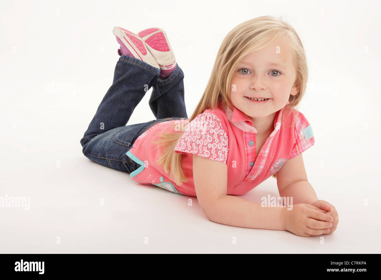 Pretty young girl lying down on her front Stock Photo - Alamy