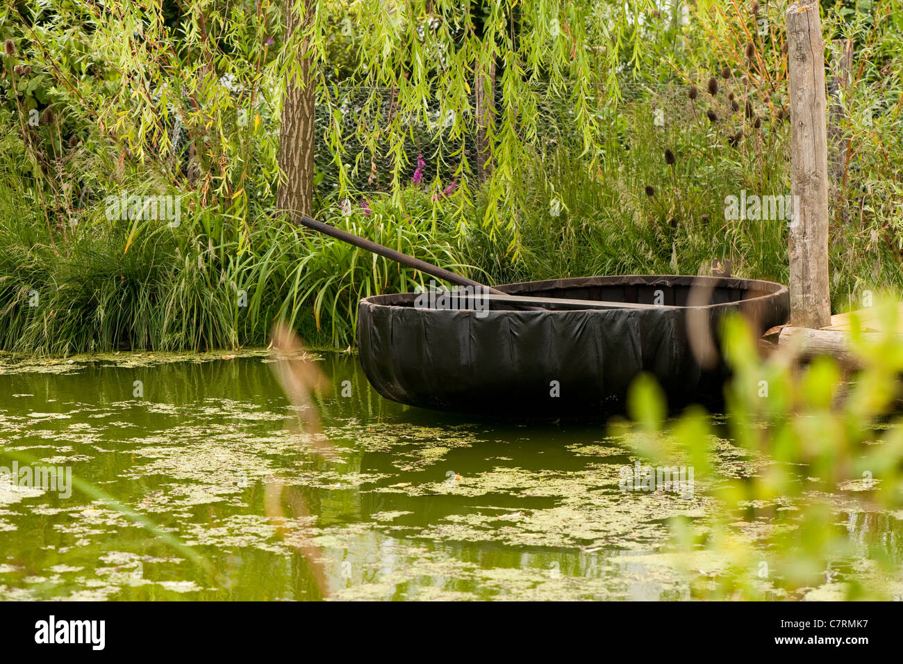 Coracle in the pond area in the RHS Edible Garden at 2011 Hampton Court ...