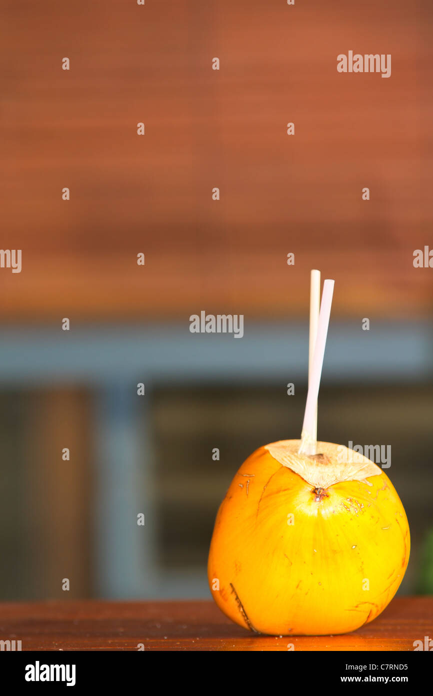 Coconut with straw Stock Photo - Alamy
