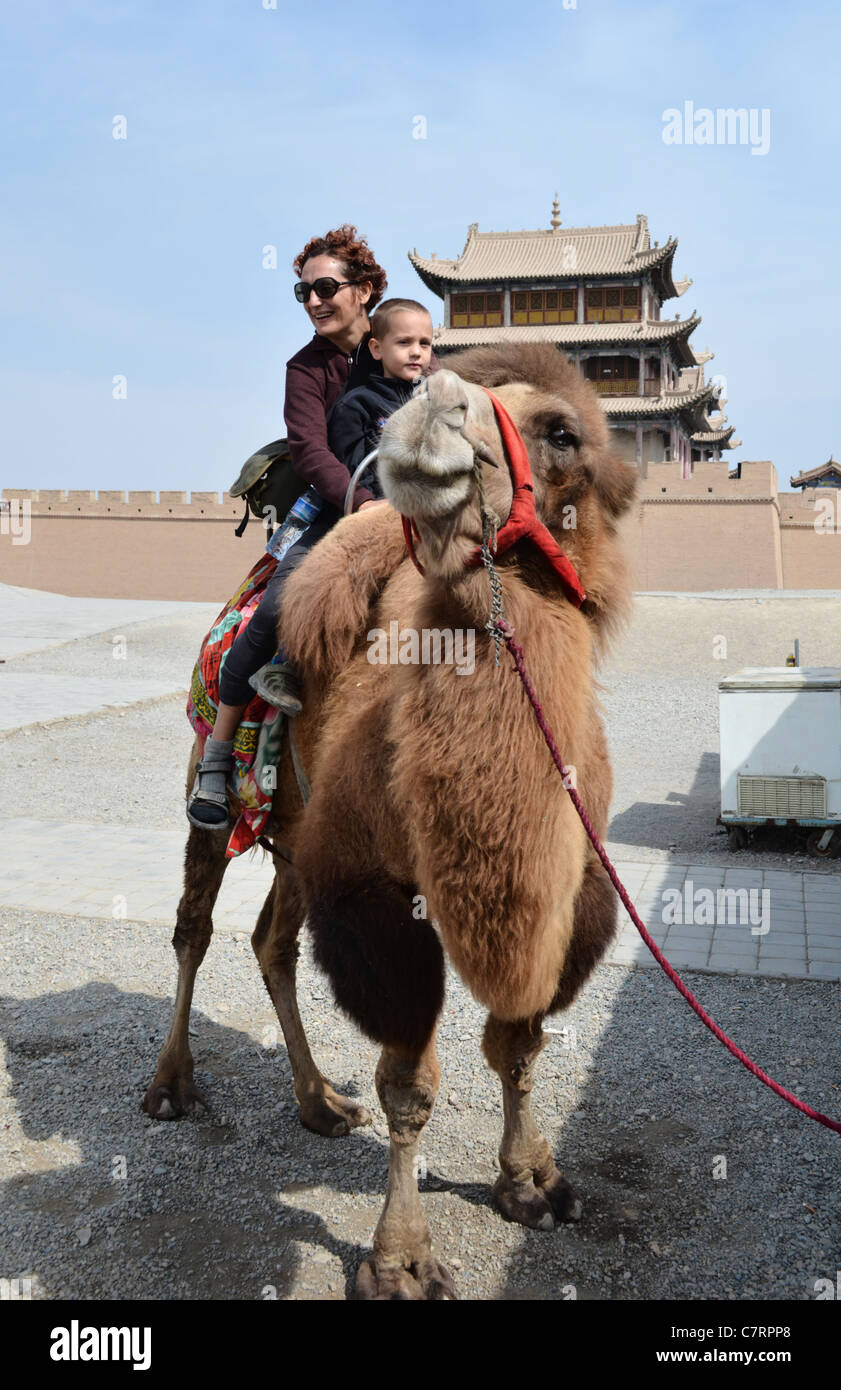 European mother and child enjoy a camel ride at the historical ...